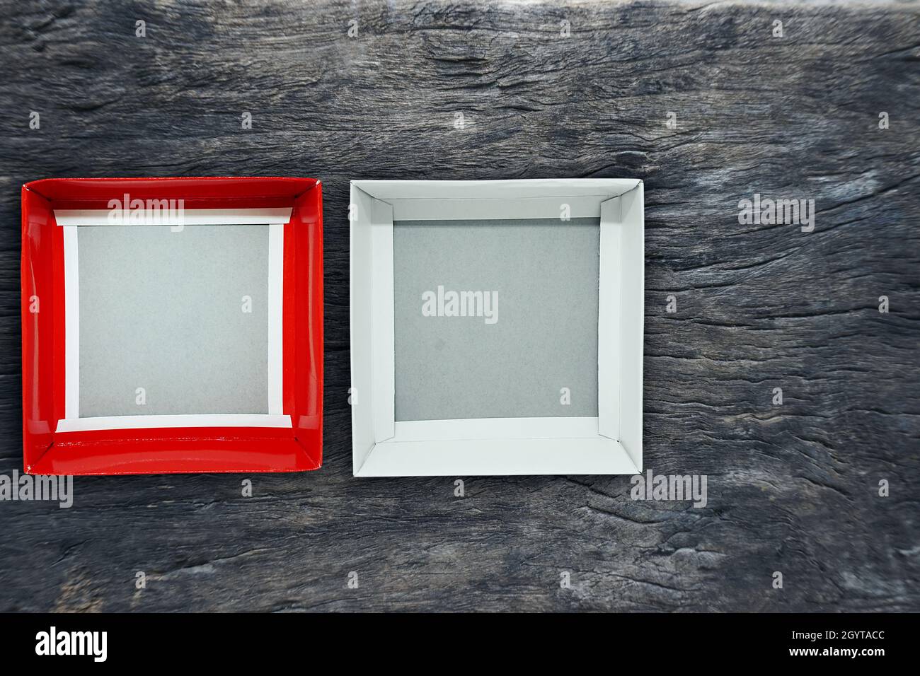 Top view open blank box white gray with cover red on a retro wood table ...