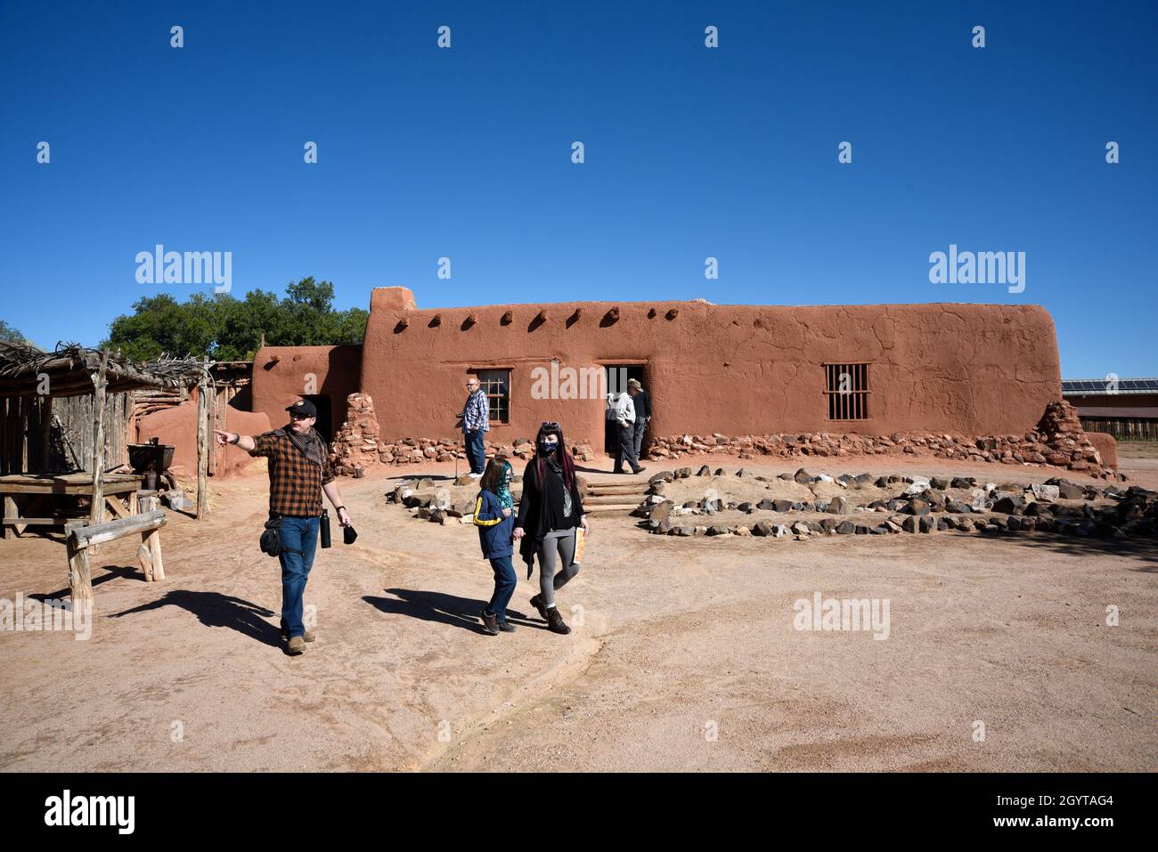 Tourists visit adobe adobe structures El Rancho de las Golondrinas ...