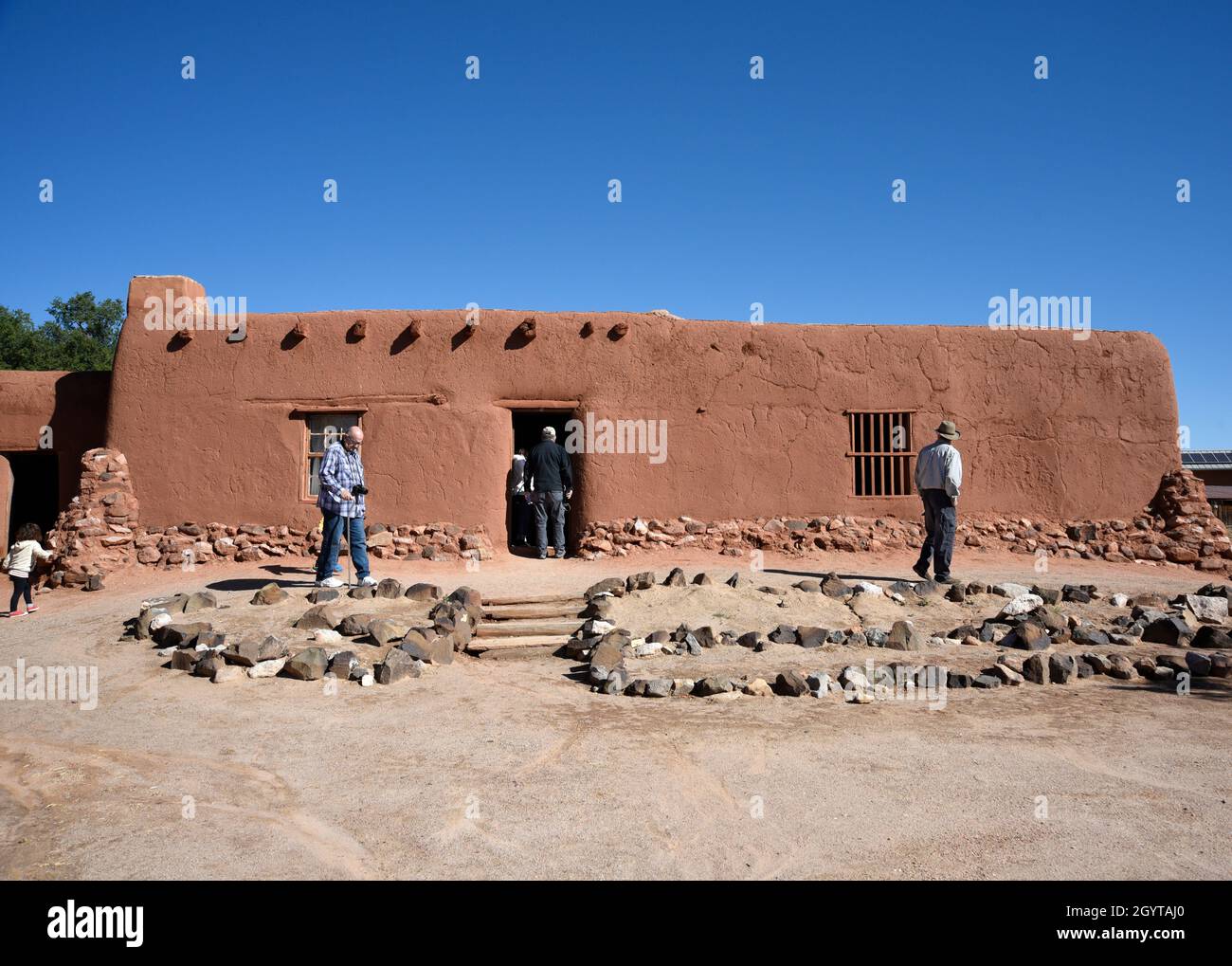 Tourists visit adobe adobe structures El Rancho de las Golondrinas ...