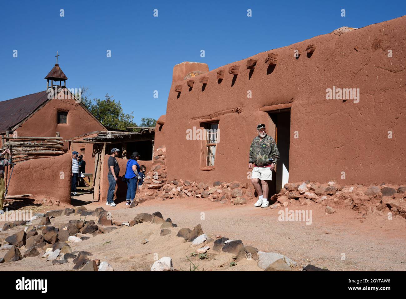 Tourists visit adobe adobe structures El Rancho de las Golondrinas ...