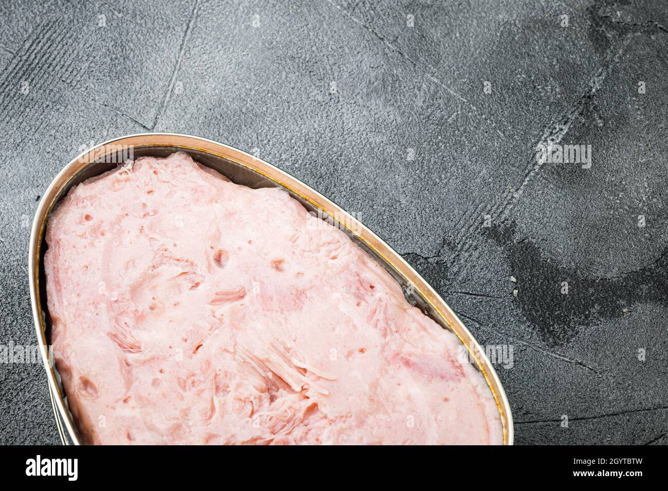 Canned ham set, on gray stone table background, with copy space for ...