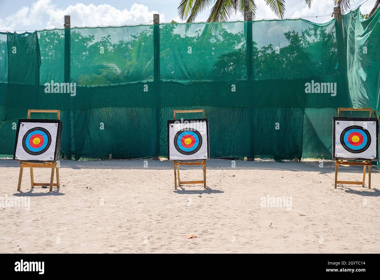 Three colorful target board or dartboards on beach sand in front of ...
