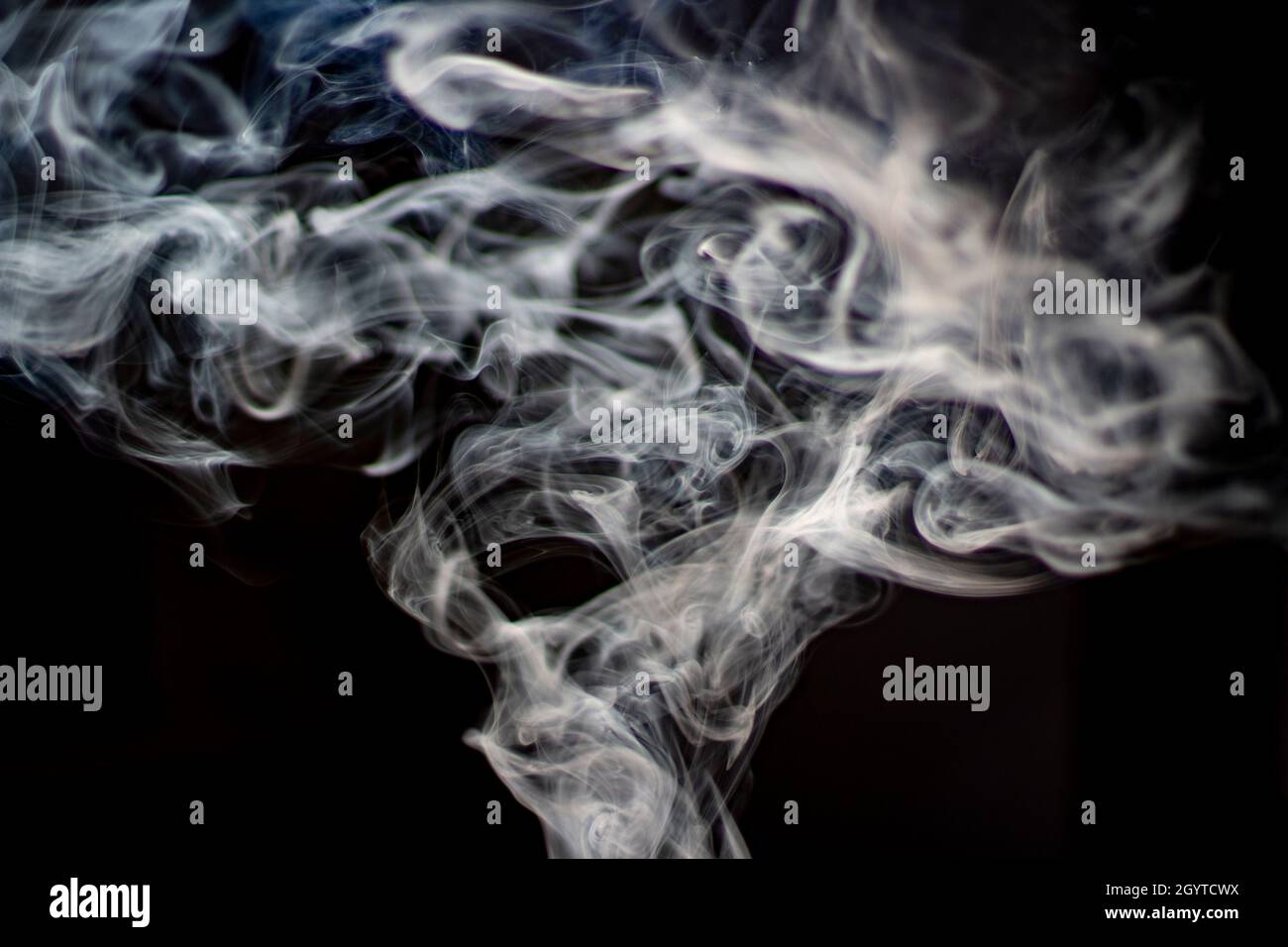 Smoke in natural light. Tobacco smoke fills the air. Clubs of steam in ...