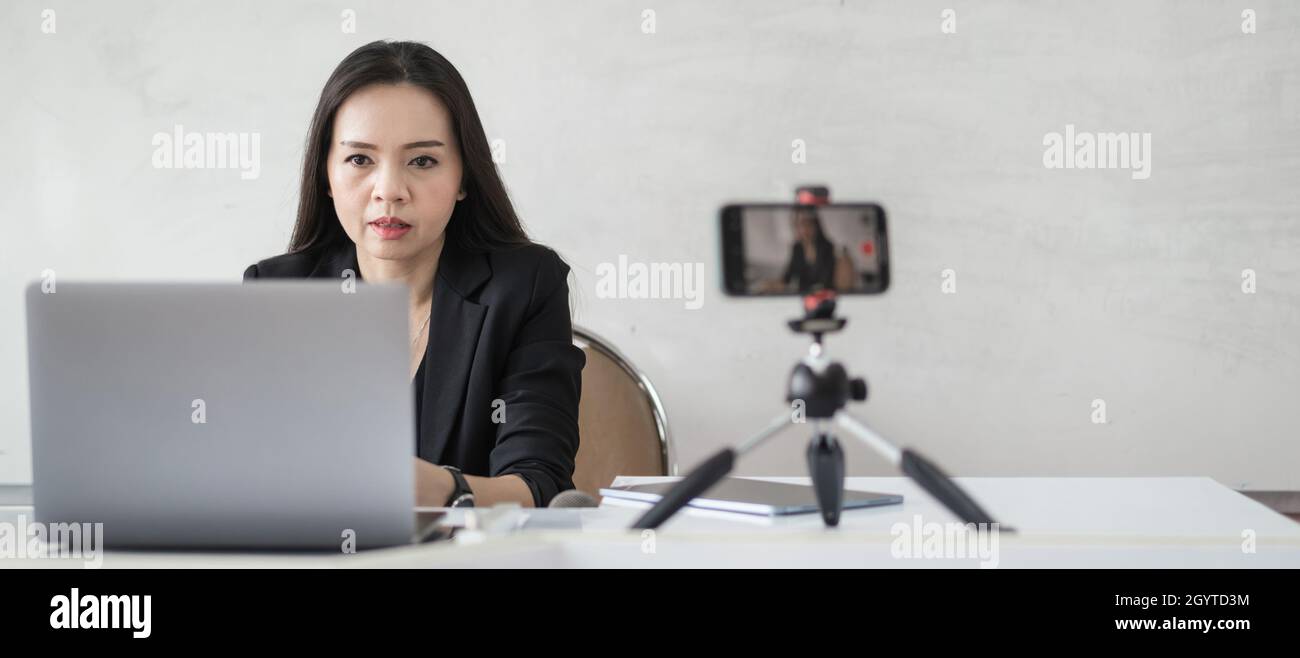 Asian female tutor teaching online via video conference meeting to ...