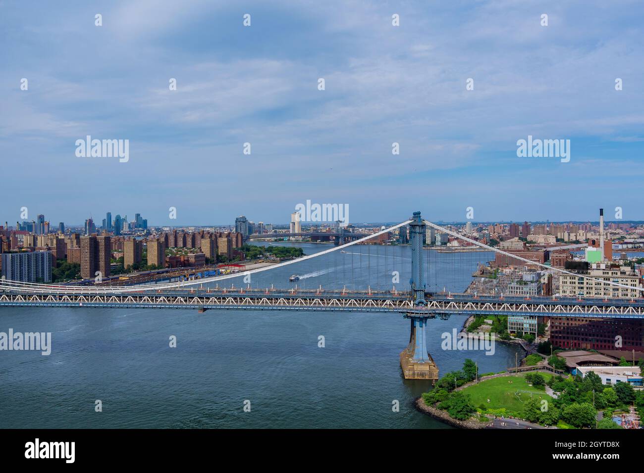 Aerial view of the Manhattan bridge through the East river to district ...