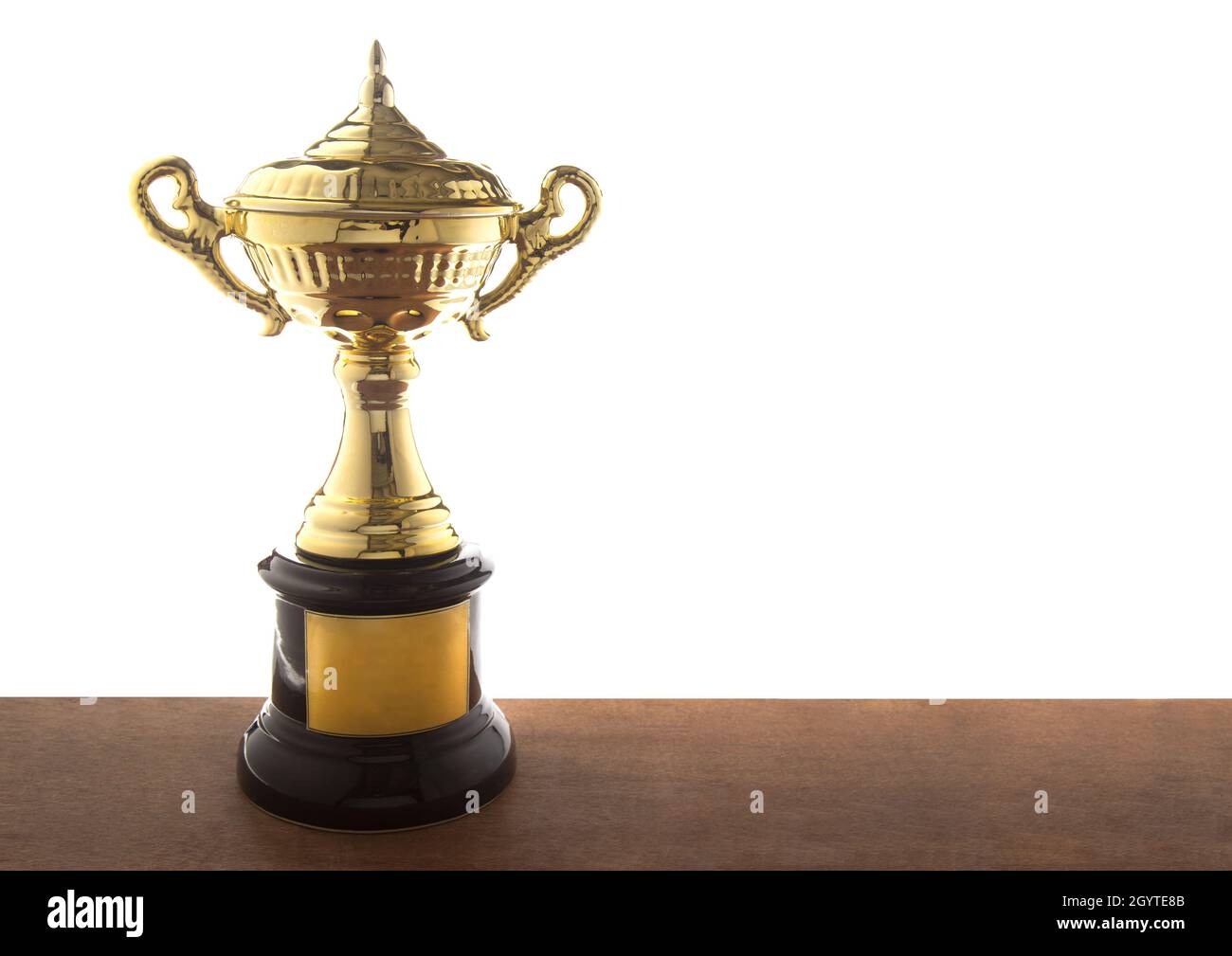 Golden trophy on wooden table isolated over white background. Winning ...