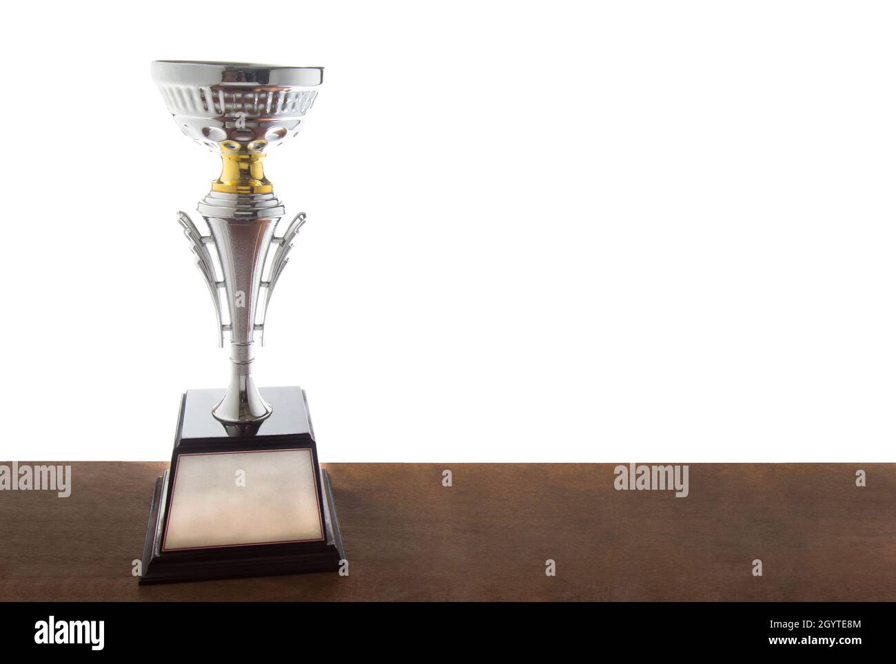 Silver trophy on wooden table isolated over white background. Winning ...