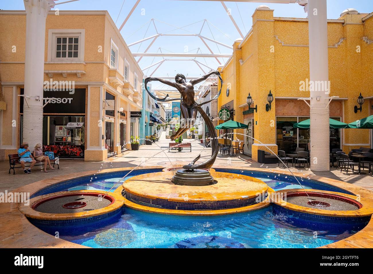 Urban shopping center with commercial shops, restaurant and fountain ...