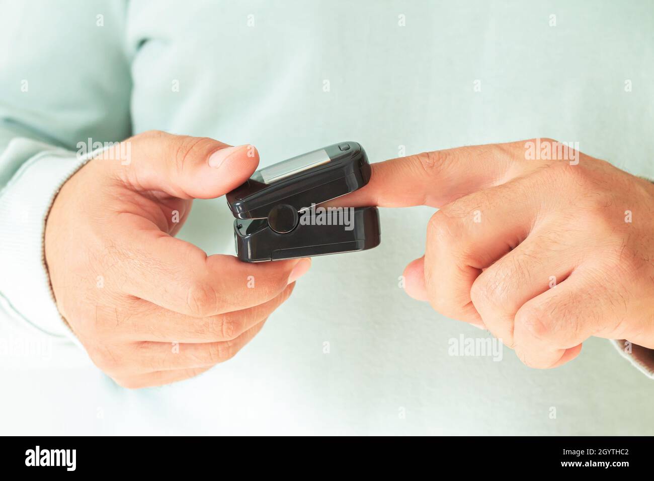 Man checking blood oxygen level with pulse oximeter at home. Health ...
