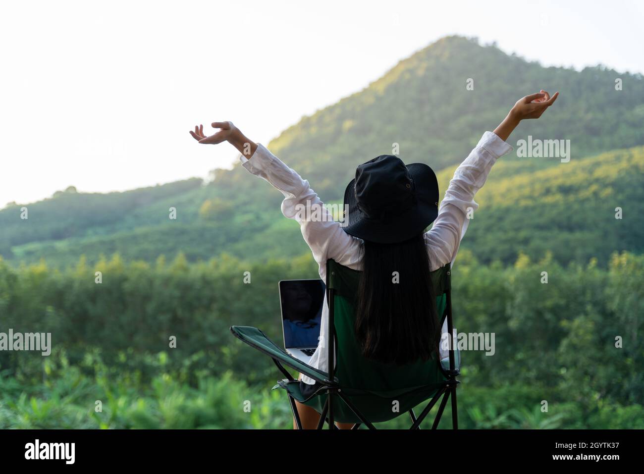 Happy woman rise hand up on top of mountain and blue sky abstract ...