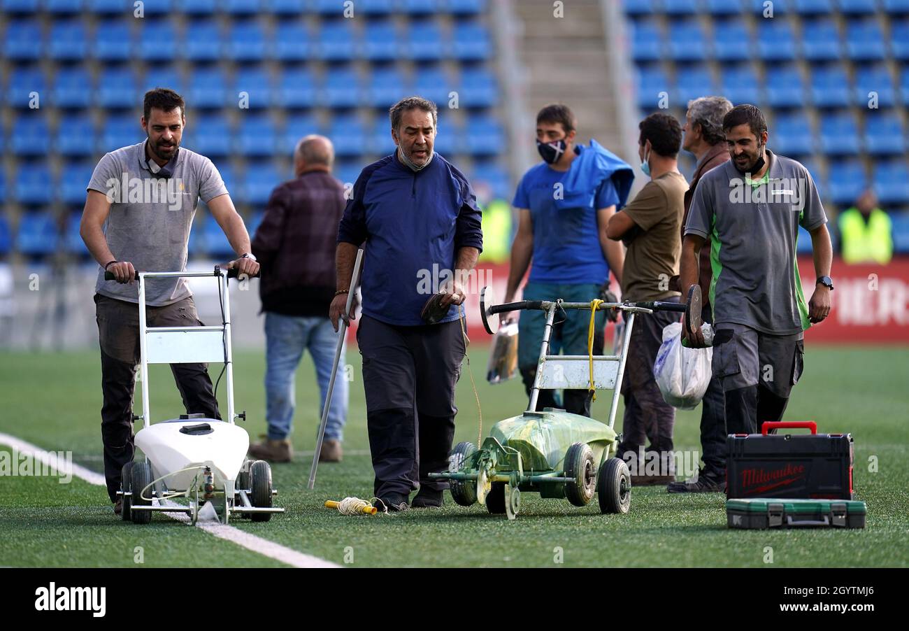 Ground staff paint the lines on the pitch ahead of the FIFA World Cup ...