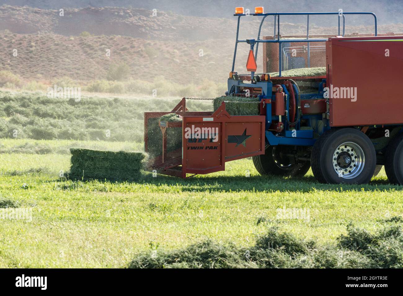 Baling hay with a John Deere 7930 tractor and a GPT Twin Pak baler on a ...