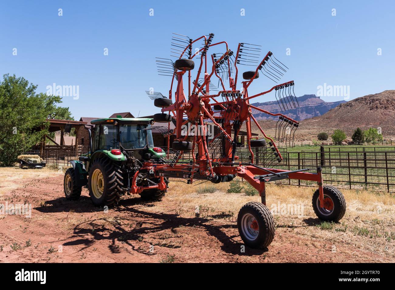 a-rotary-rake-combines-smaller-rows-of-hay-into-one-larger-row-to