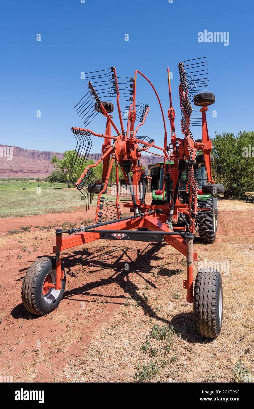 a-rotary-rake-combines-smaller-rows-of-hay-into-one-larger-row-to