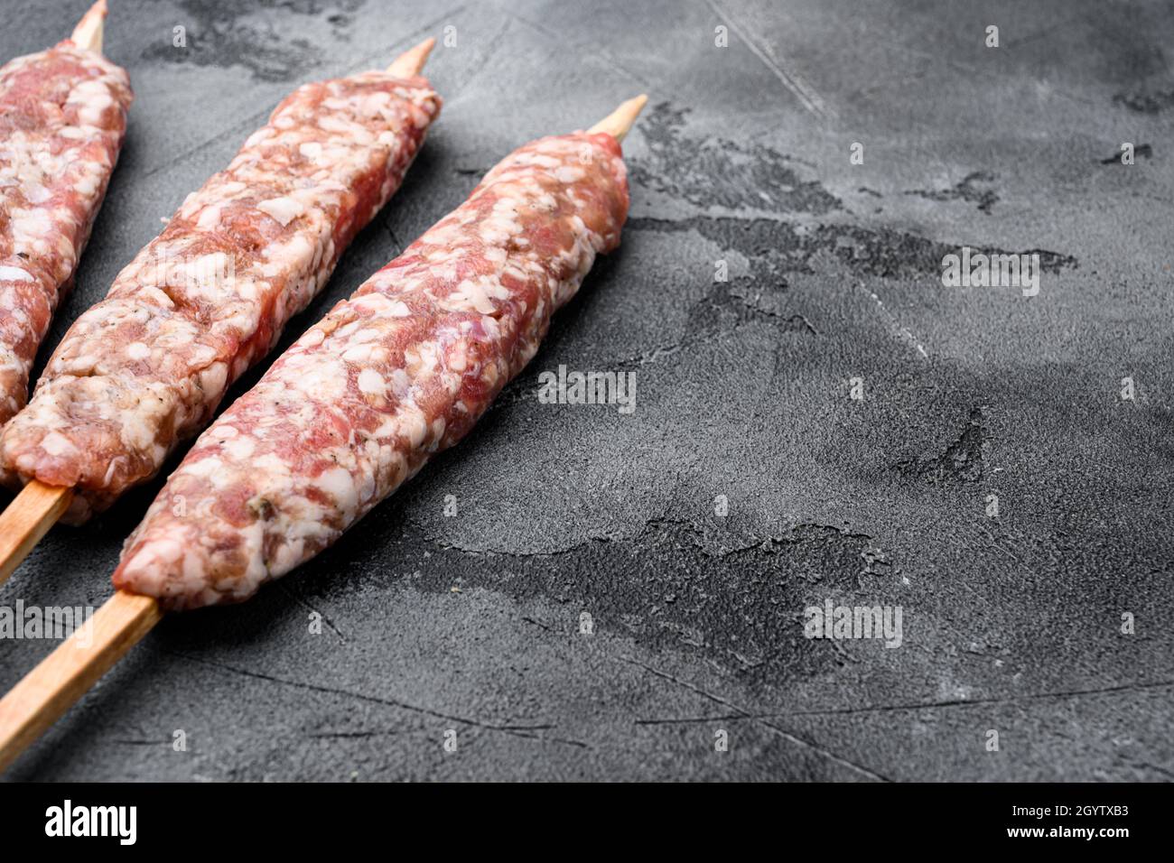 Lyulya kebab, meat dish for cooking set, on gray stone table background ...