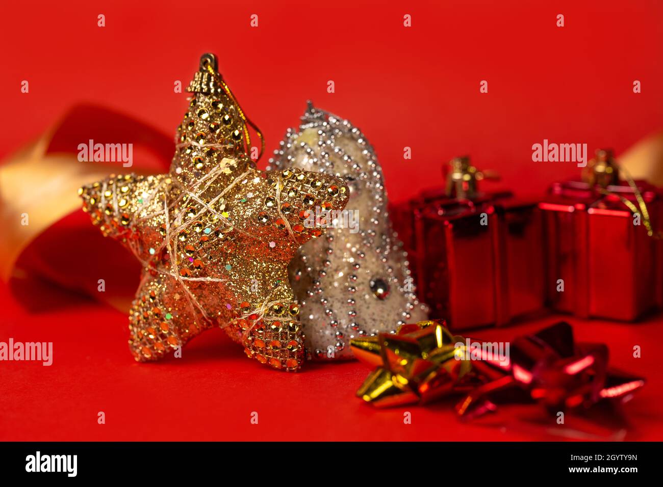 christmas toy golden star on a red background Stock Photo - Alamy