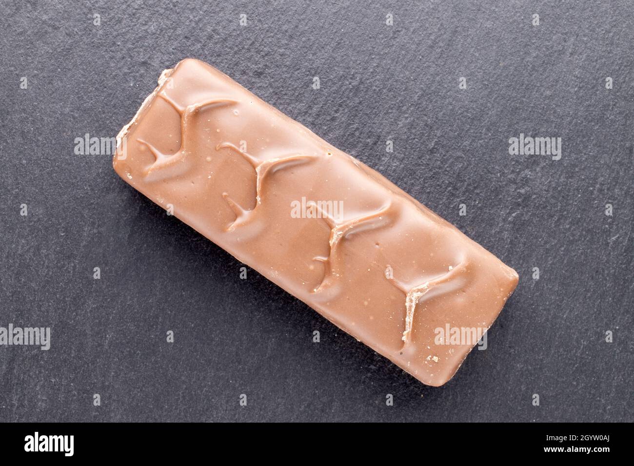One chocolate bar, close-up, on a slate stone, top view Stock Photo - Alamy