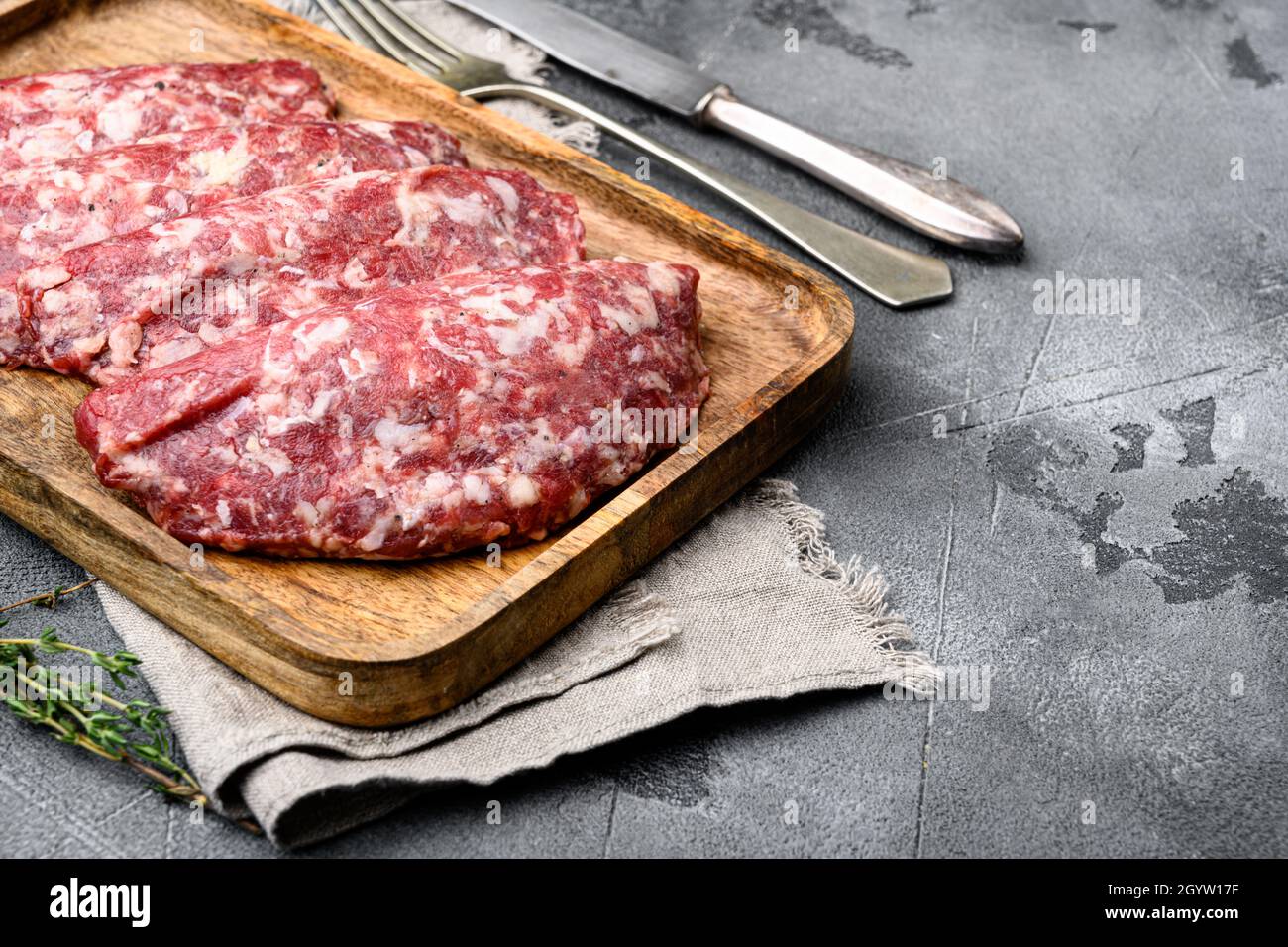 Ground raw meat patties. Meat patty set, on gray stone table background ...