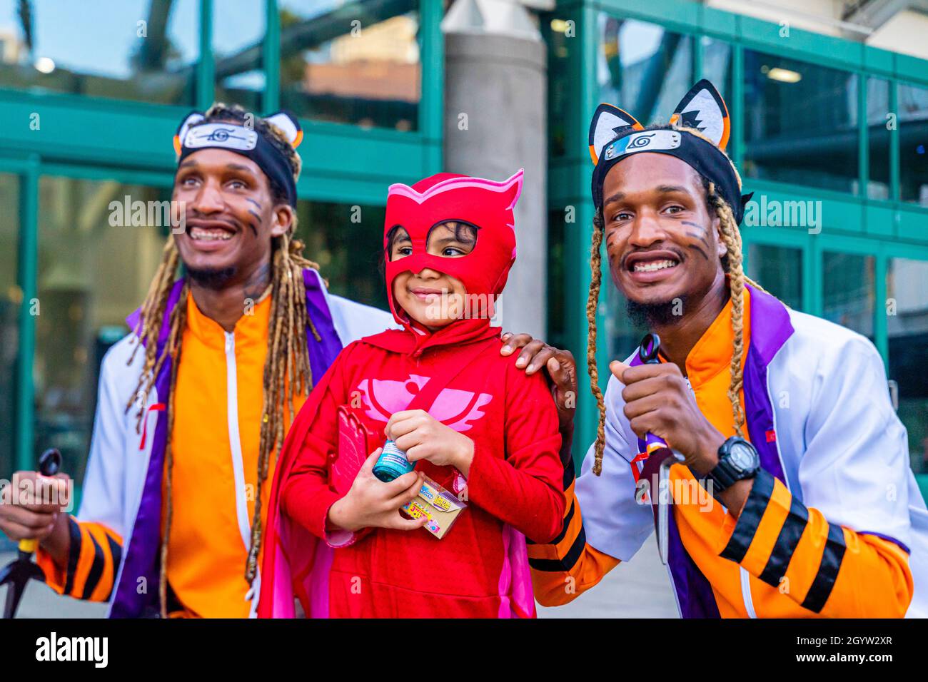 Attendees, men and a kid portraying posing cats at Comic Con in Los ...