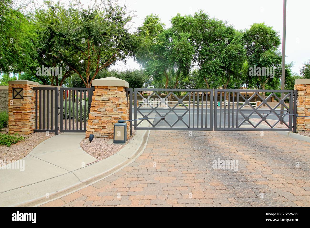 Electric Exit Gate With Flagstone Columns Stock Photo - Alamy