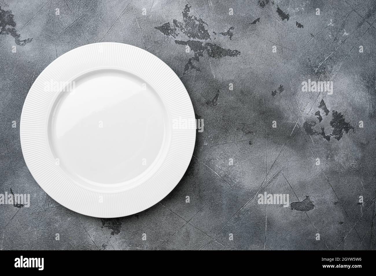 White plate empty utensil set with copy space for text or food with ...