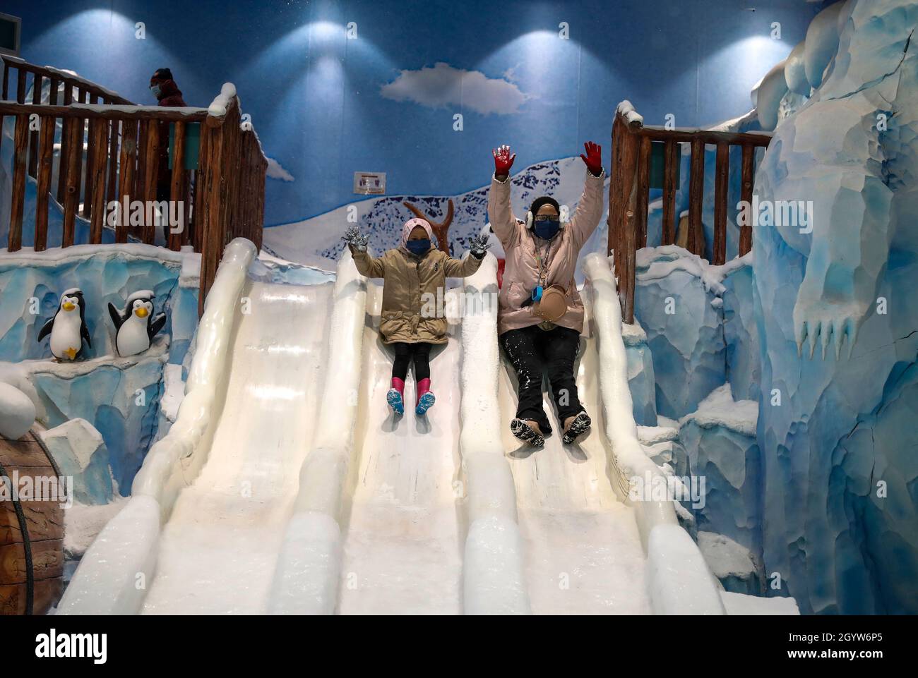 Visitors are seen playing at thei-City SnoWalk, Shah Alam, on the ...