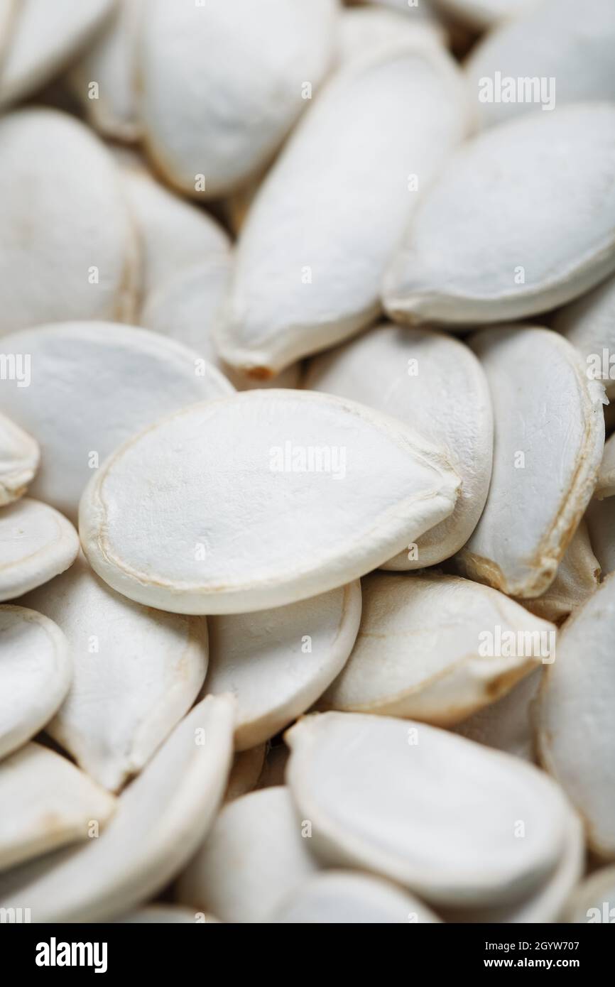 Pumpkin seeds in a shell close-up, macro as a background. full screen ...