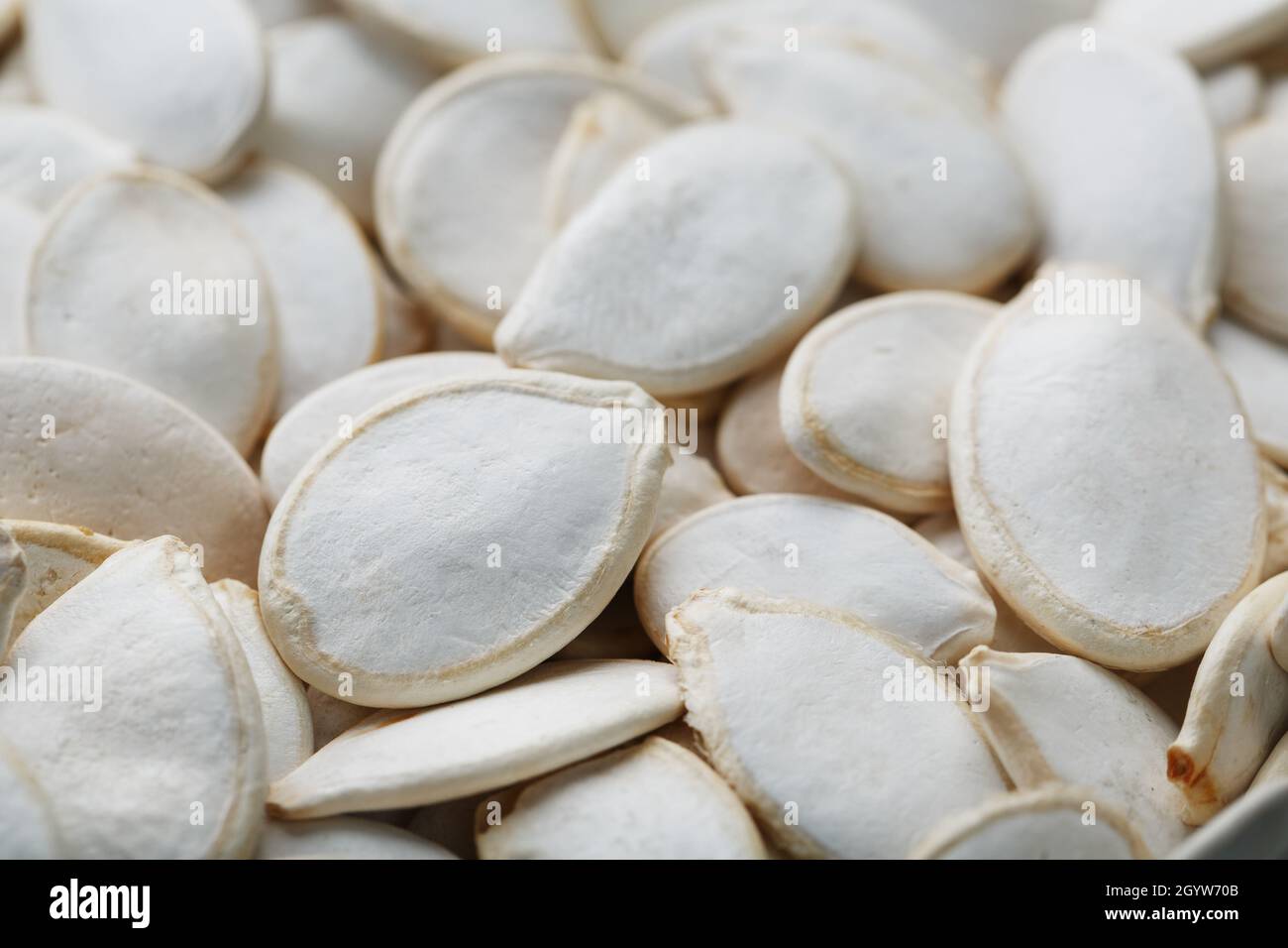 Pumpkin seeds in a shell close-up, macro as a background. full screen ...