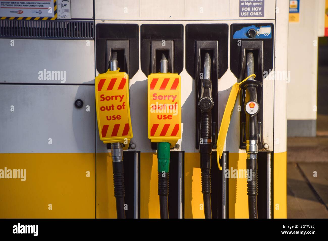 'Sorry, Out Of Use' signs cover the fuel pumps at a Shell petrol ...