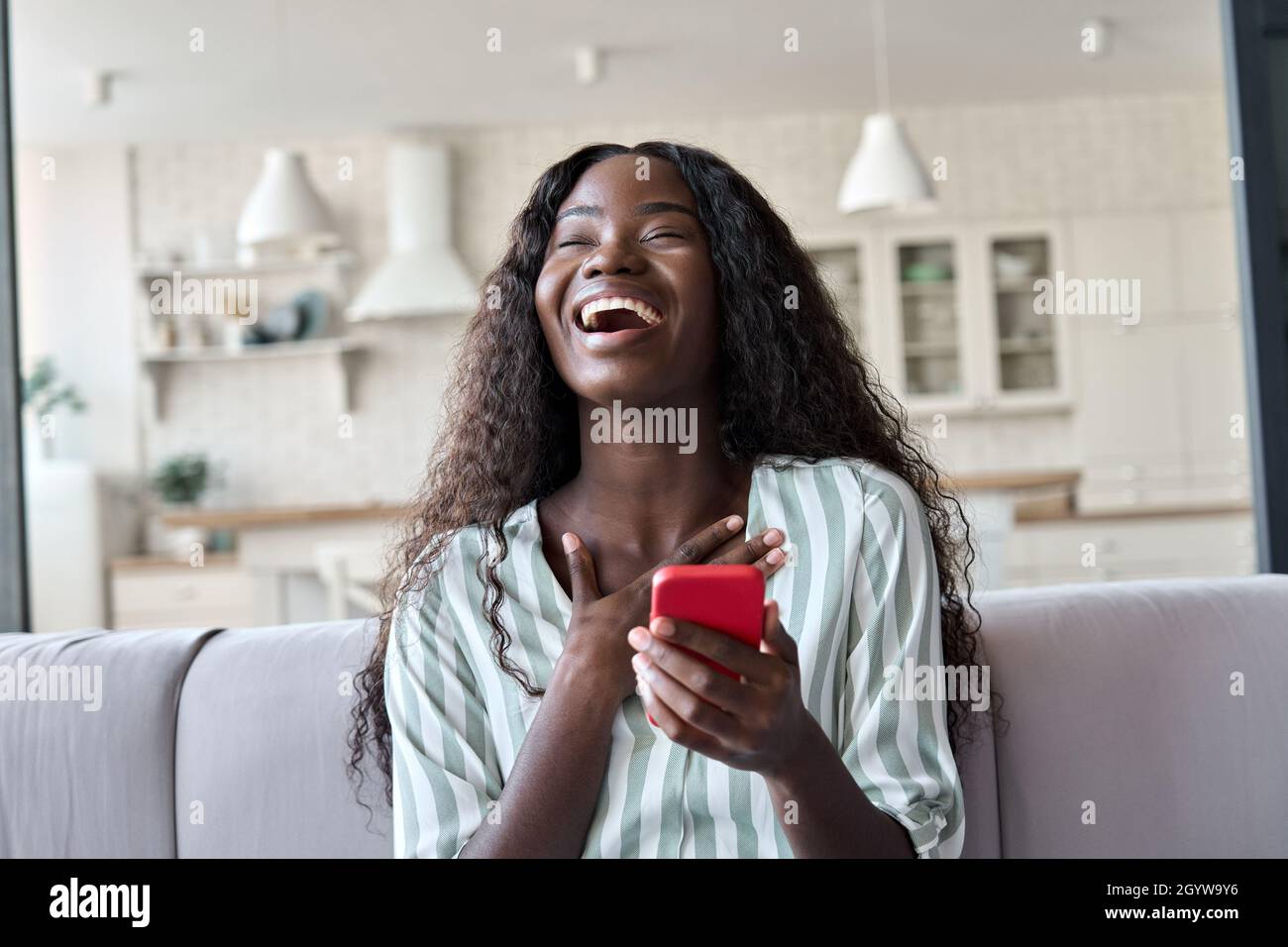 African woman mobile phone excited hi-res stock photography and images ...