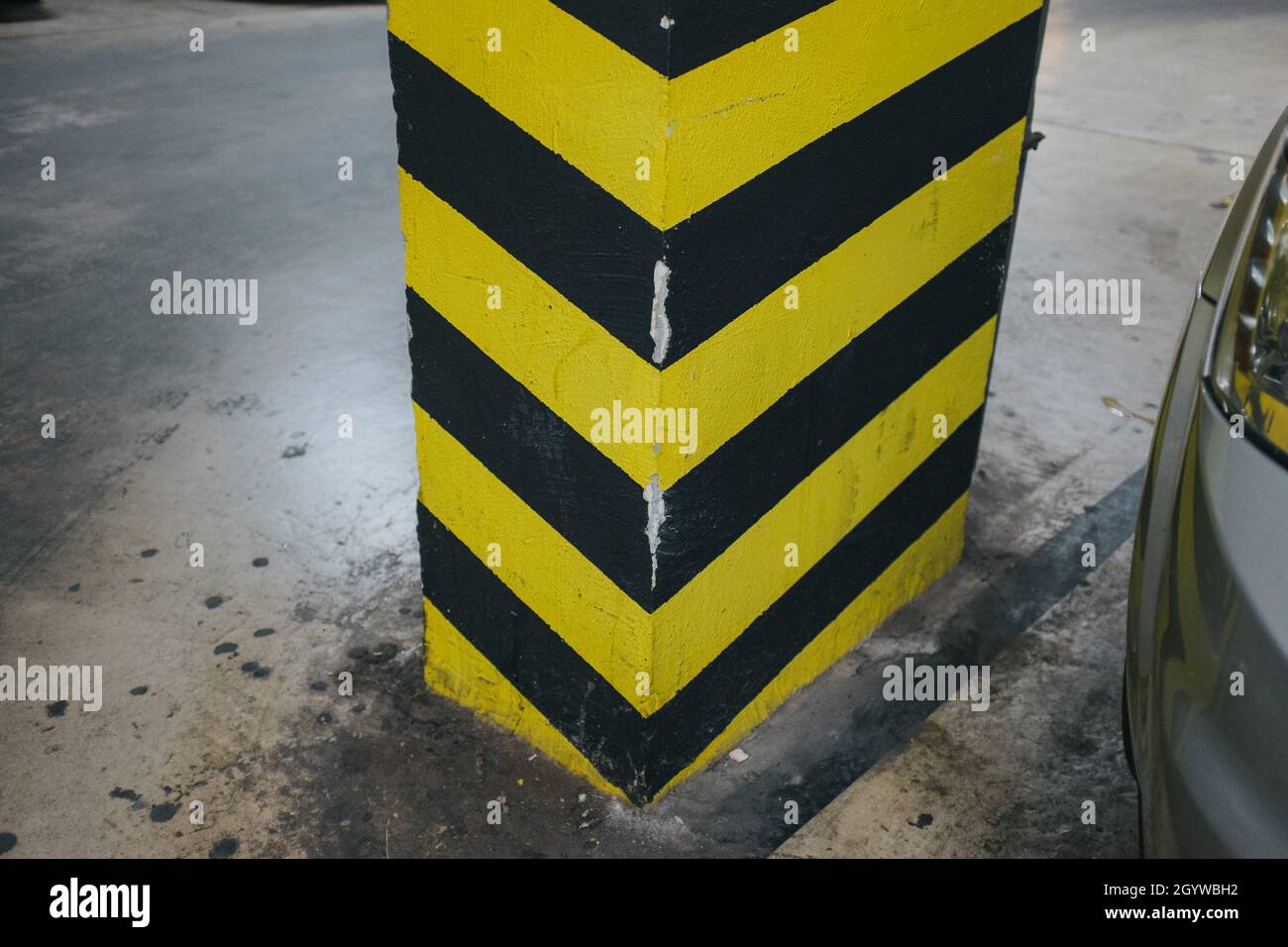 Column painted in yellow and black colors - road signal markings Stock ...