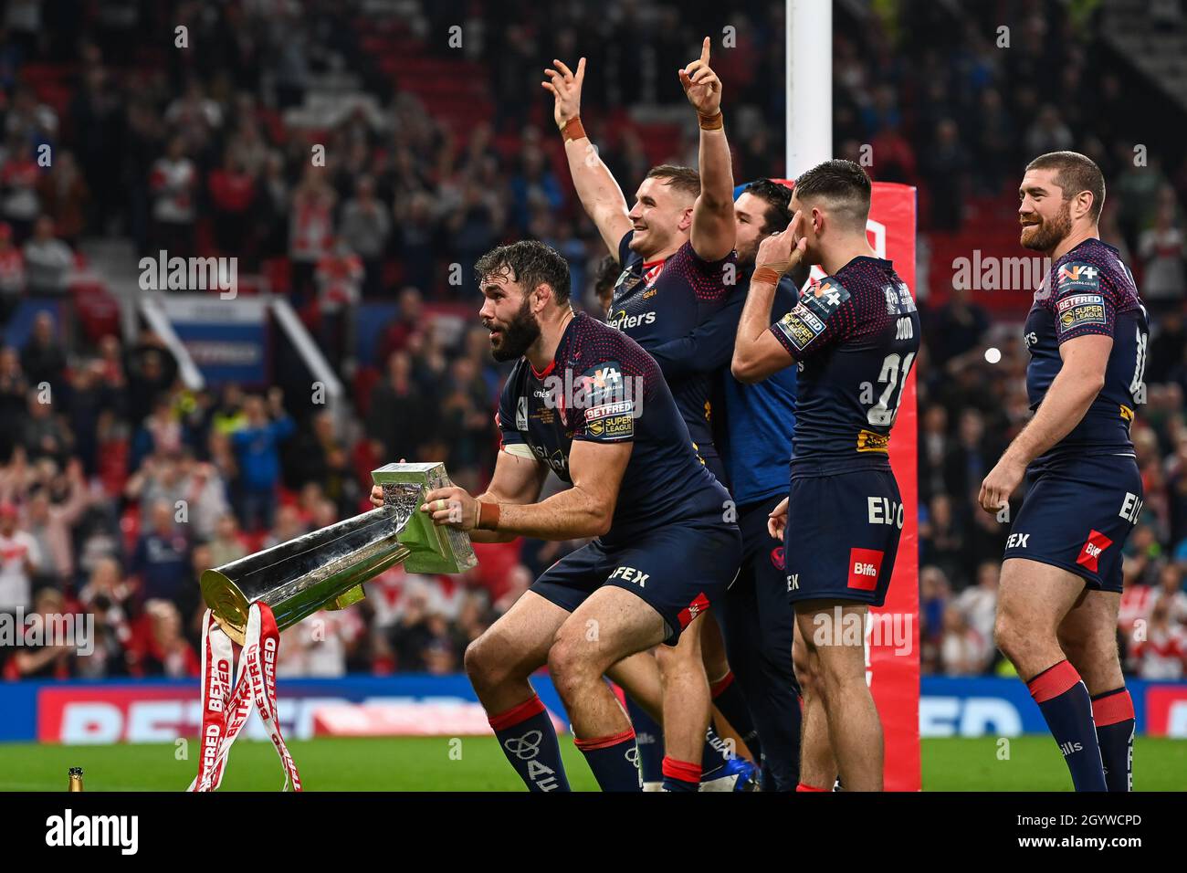 Alex Walmsley (8) of St Helens prepares to lift the grand final trophy ...