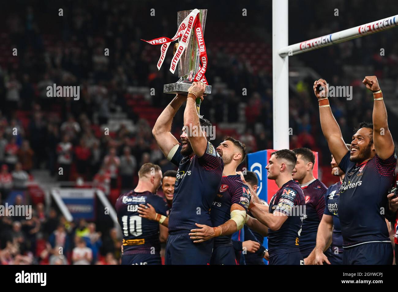 Alex Walmsley (8) of St Helens prepares to lift the grand final trophy ...