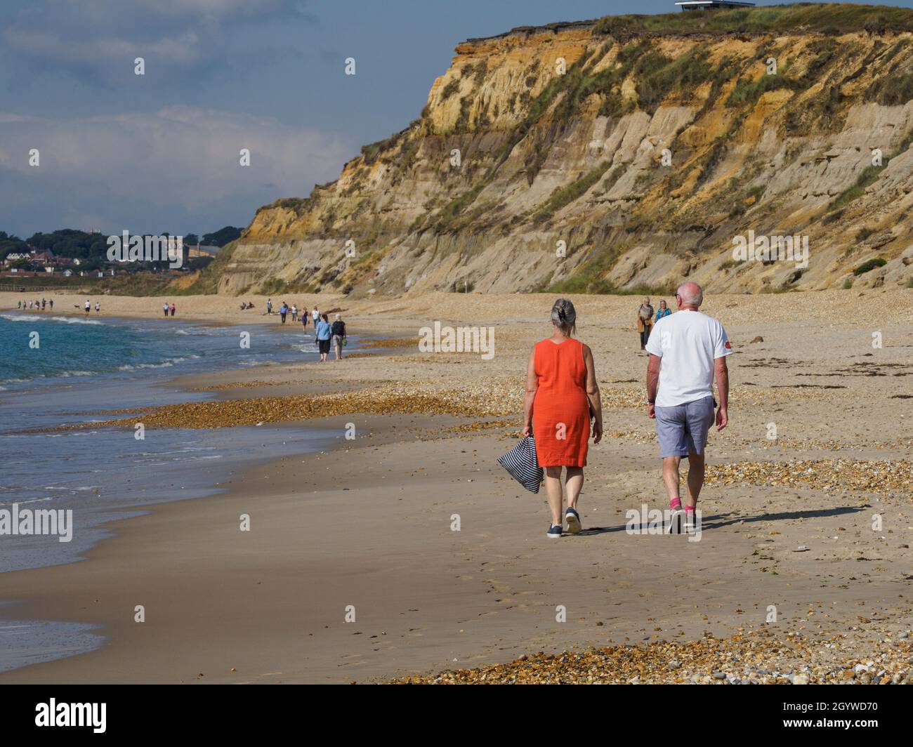 Old couple walking along beach hi-res stock photography and images - Alamy