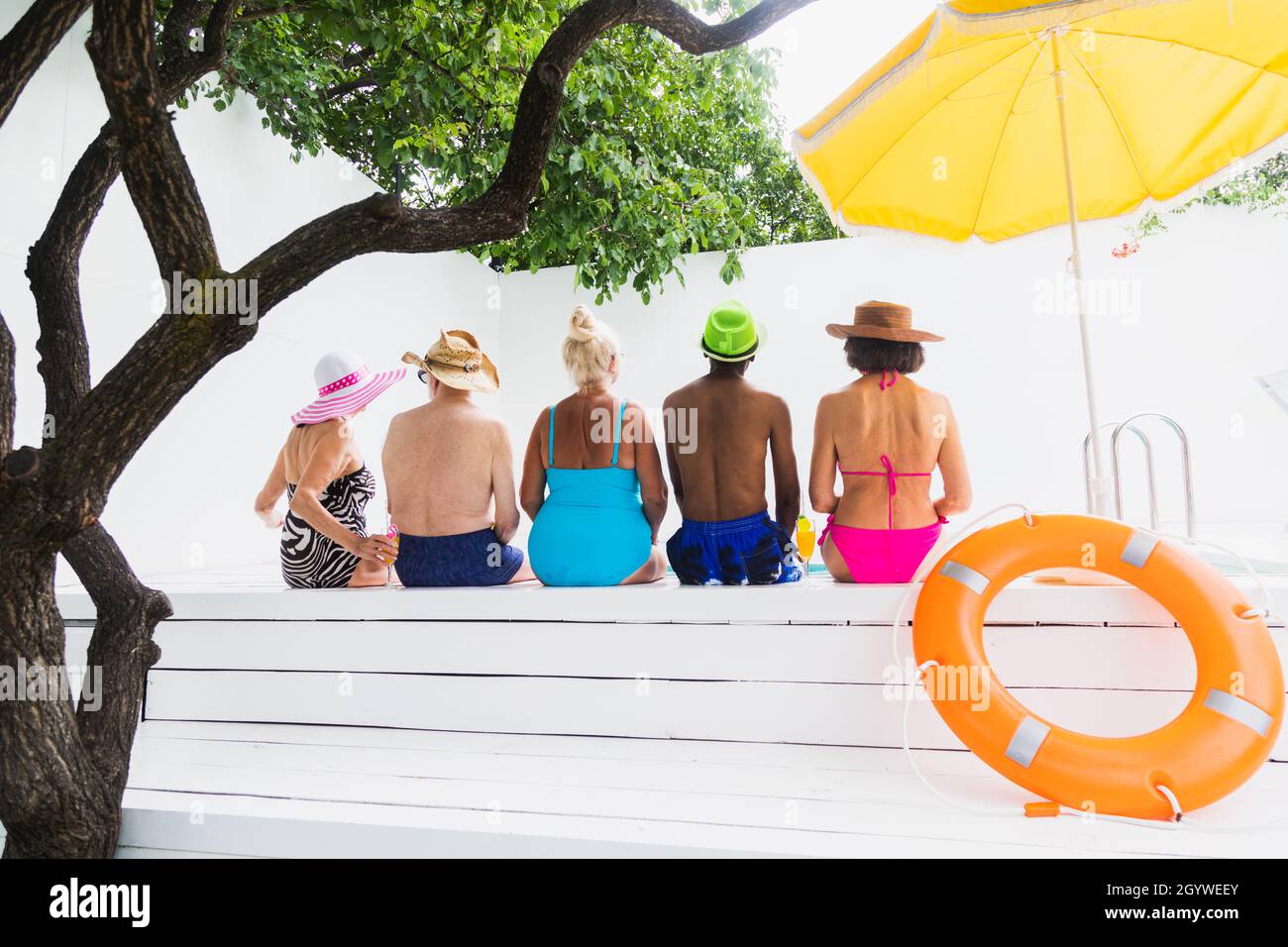 Happy seniors having party in the swimming pool - Elderly friends at a ...