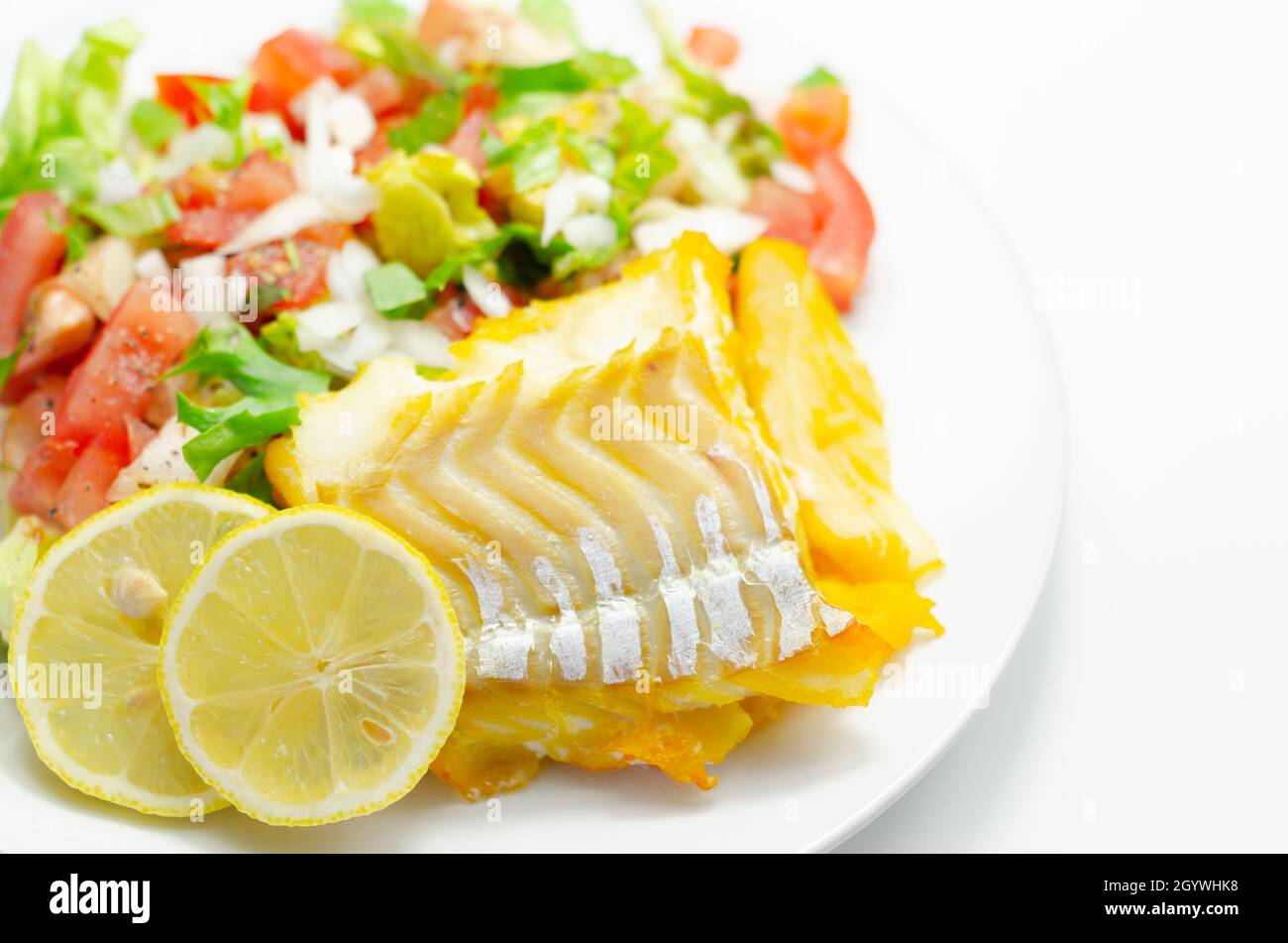 Smoked haddock fillet served with a fresh salad consisting of lettuce ...