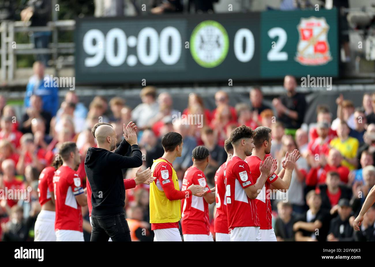 Swindon Town players and manager Ben Garner applaud the fans after the ...