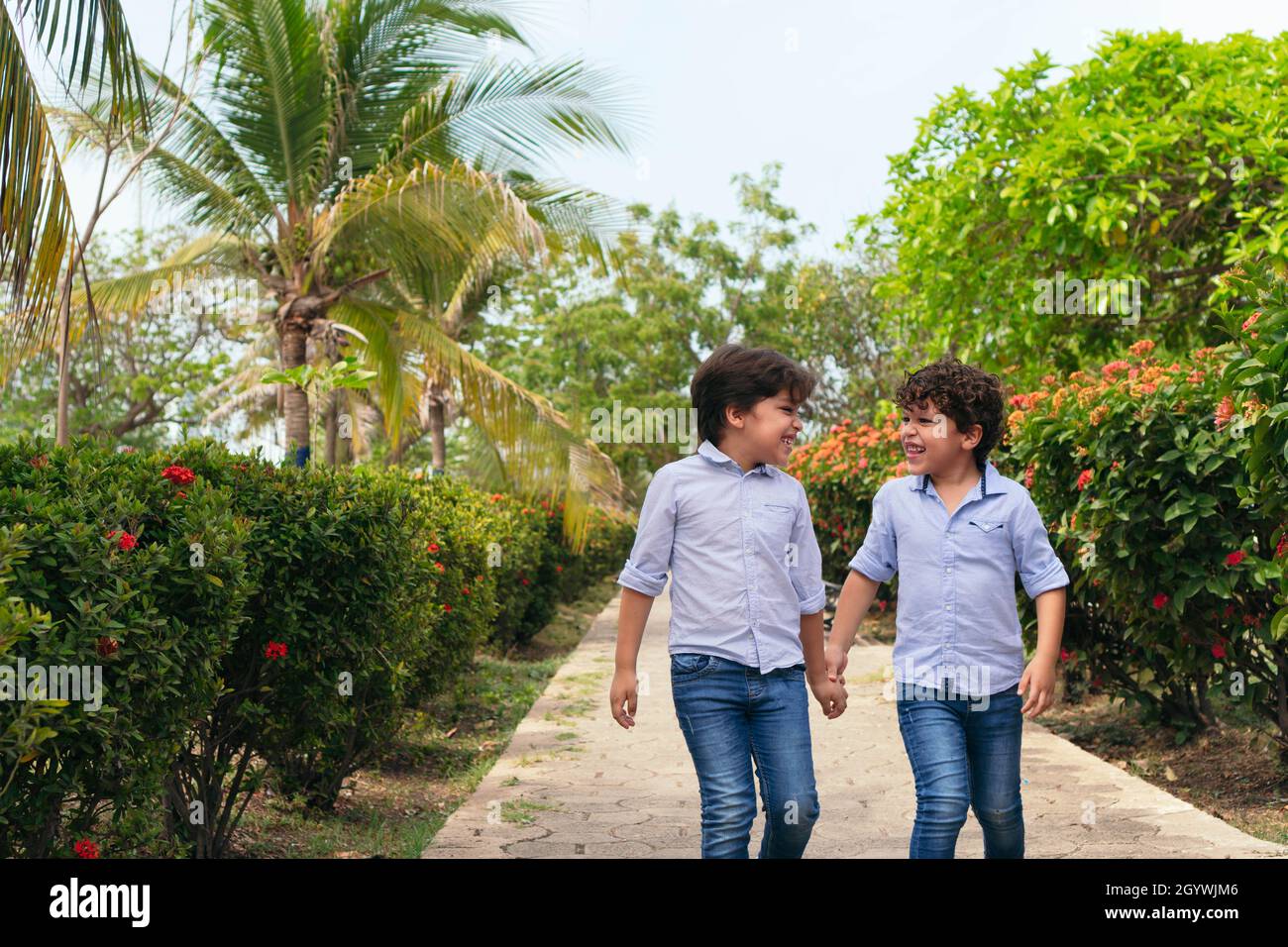 Two Hispanic siblings having fun in the park Stock Photo - Alamy