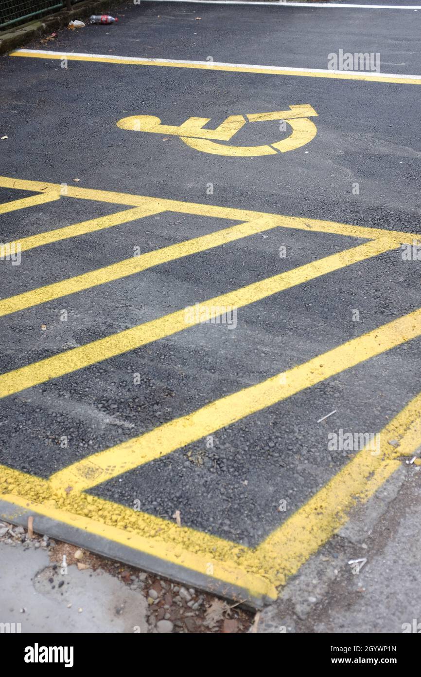 Disabled parking sign and yellow marking on the asphalt road Stock ...