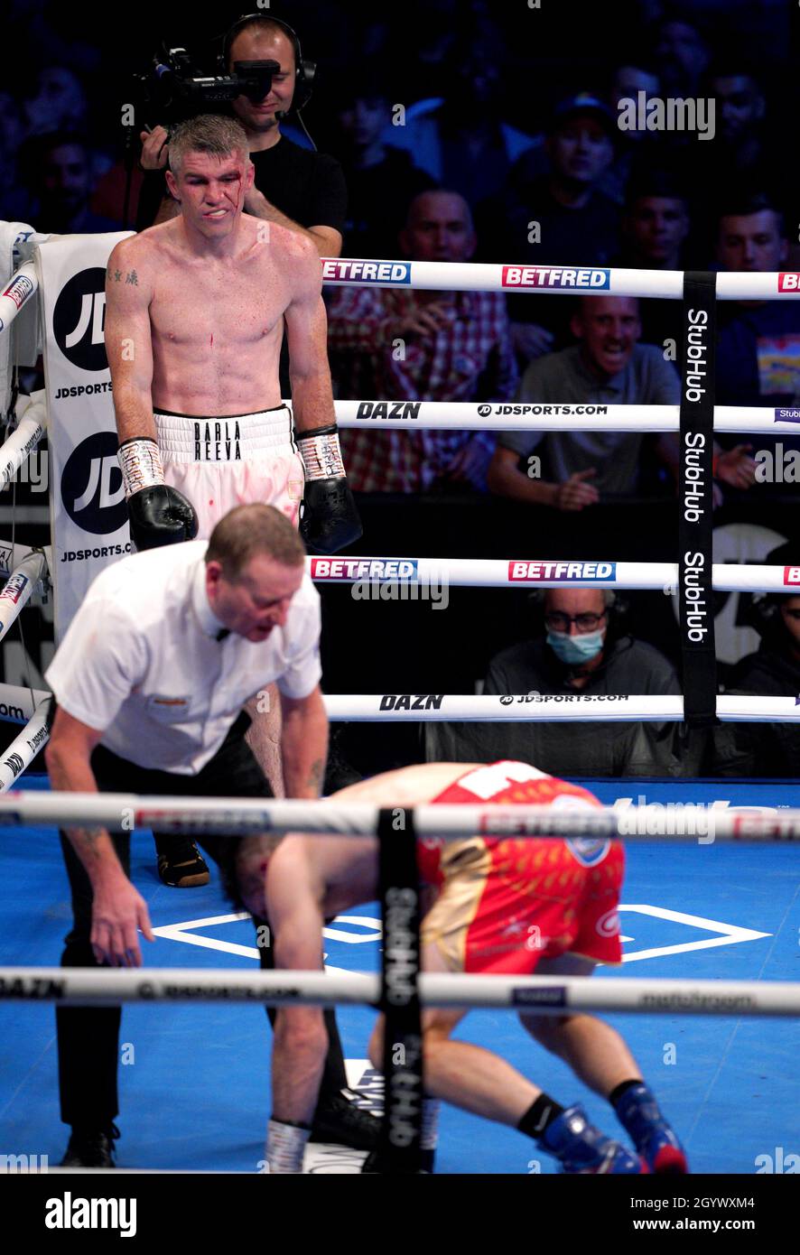 Liam Smith looks on as Anthony Fowler gets back on his feet during the ...