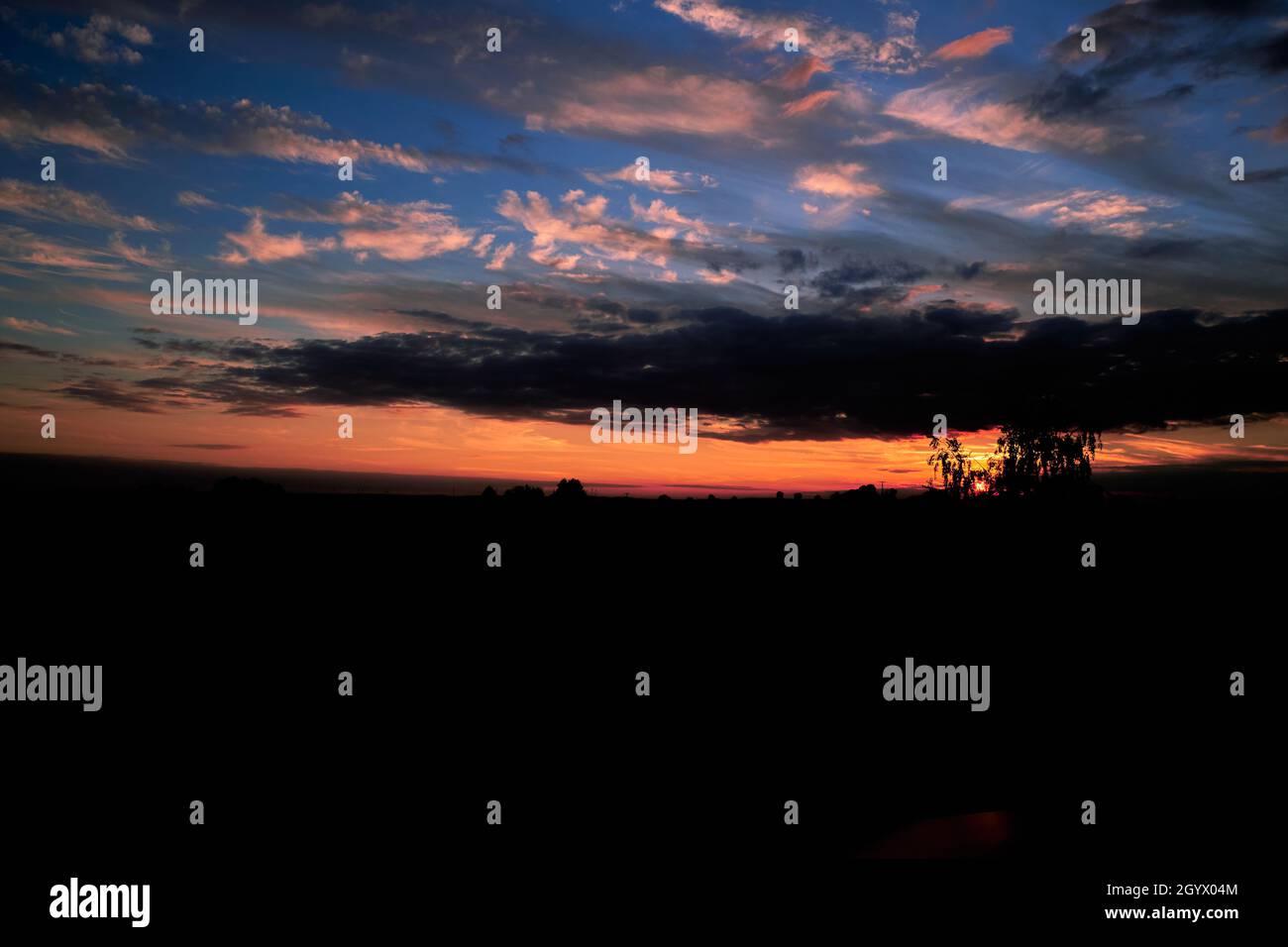 Mesmerizing sunset captured in the dark evening Stock Photo - Alamy