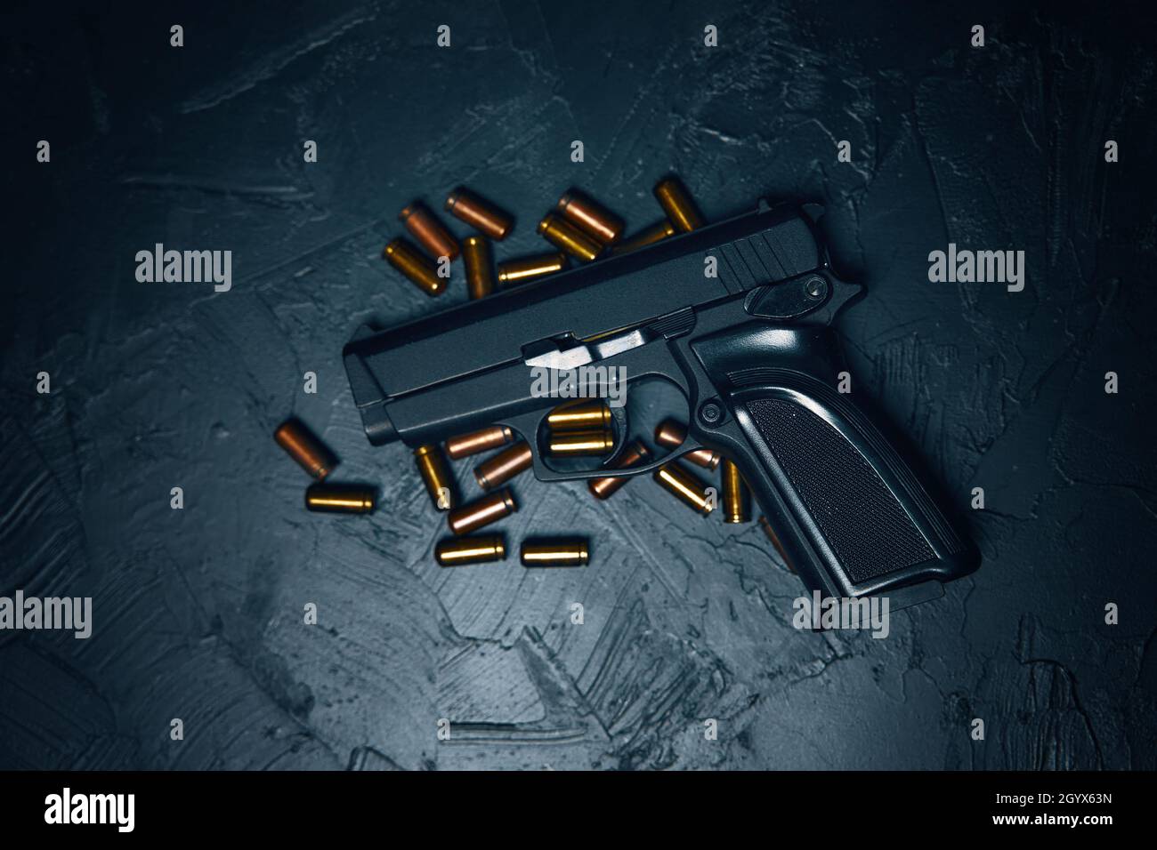 Flat lay of pistol and bullets. Firearms on dark background. Gun for ...