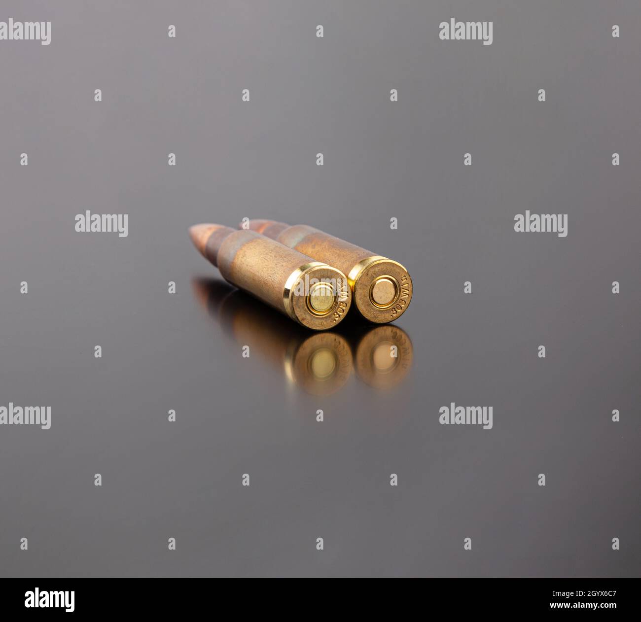Bullet isolated on black background with reflexion. Rifle bullets close ...