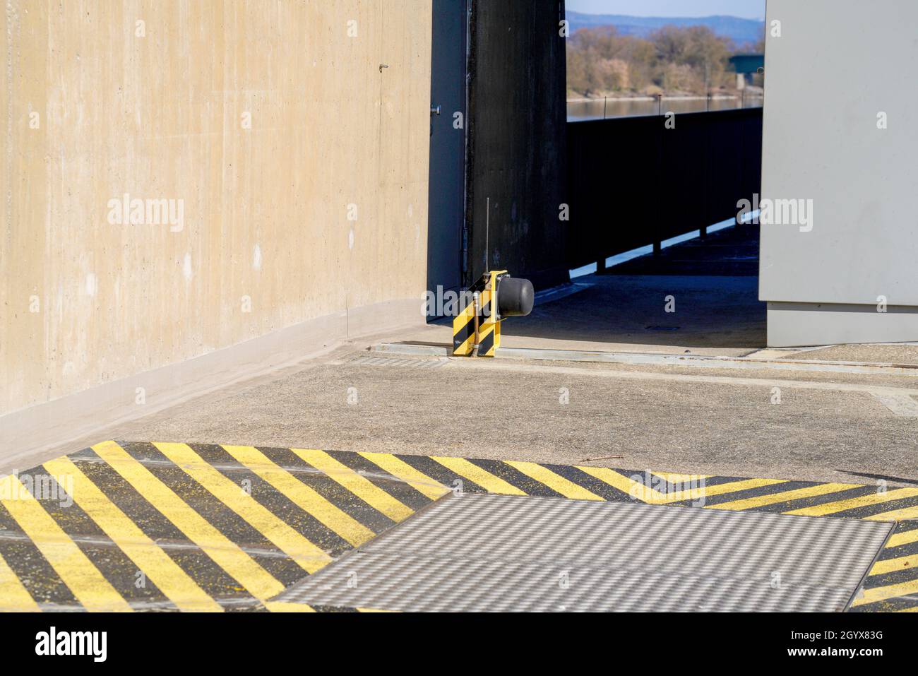 A black and yellow zebra lines in the sidewalk Stock Photo - Alamy