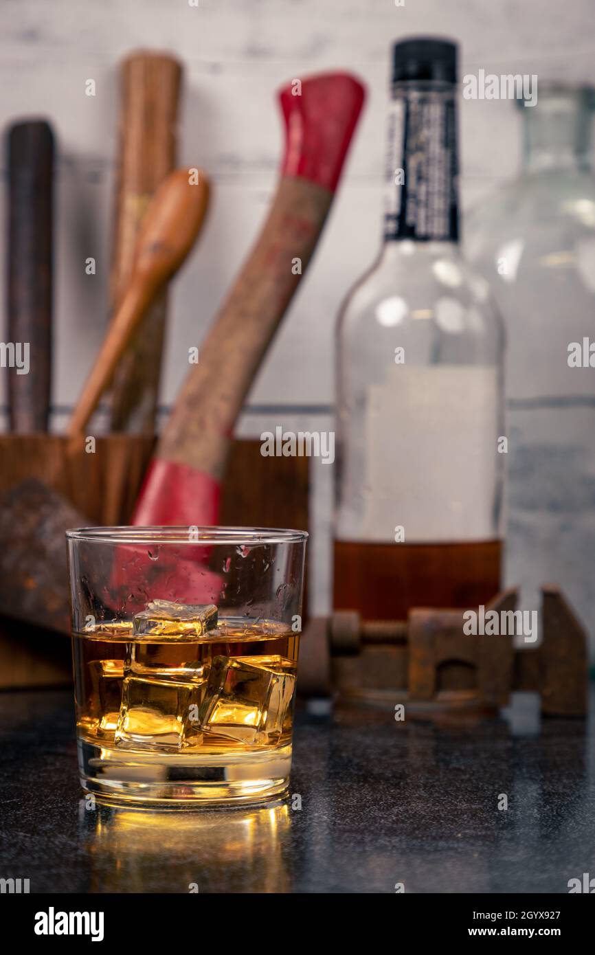Glass of Bourbon Whiskey, on the rocks, with ice, in front of vintage ...