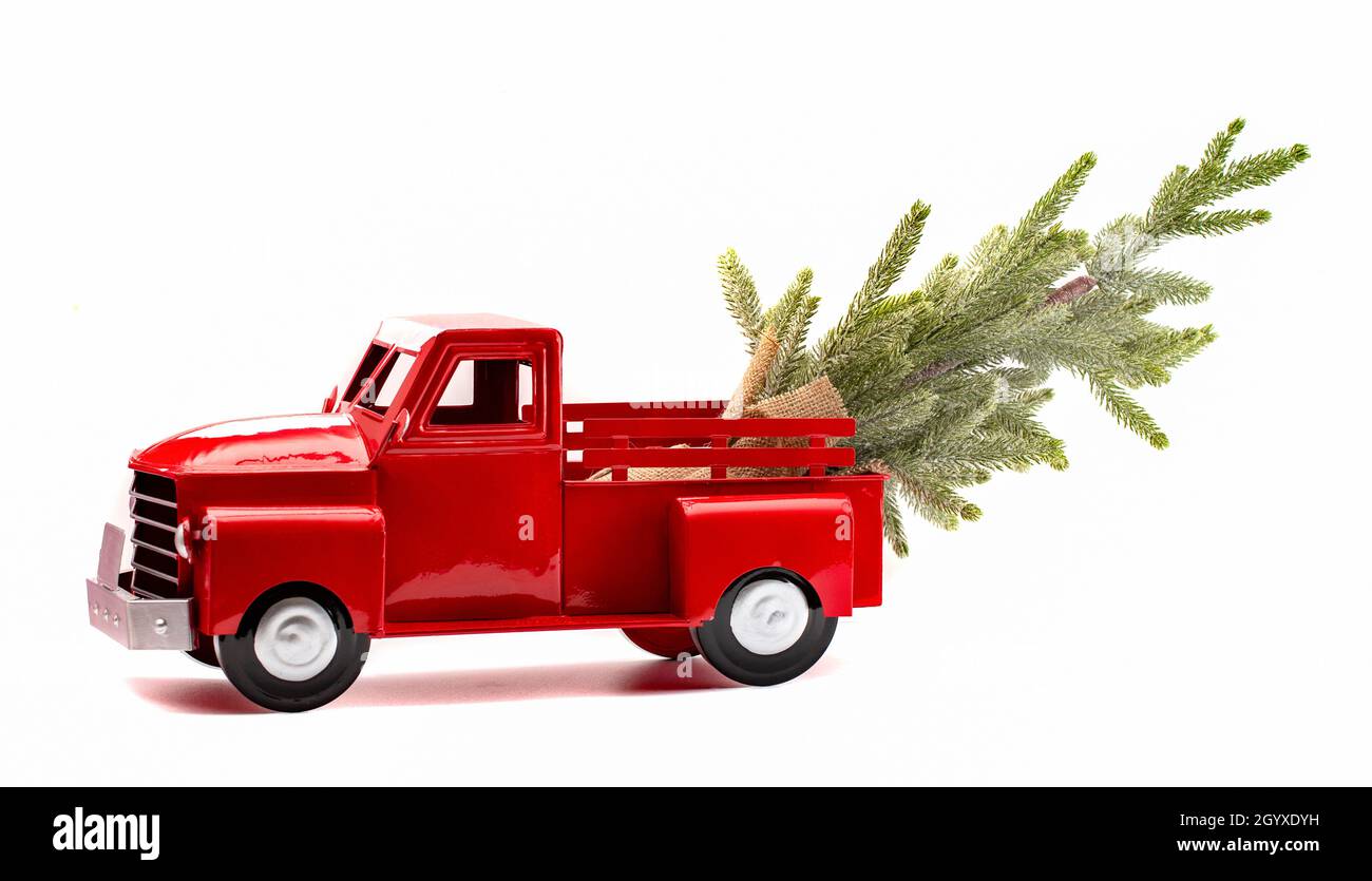 A Bright Red Pickup Truck Hauling a Pine Tree for Christmas Stock Photo ...