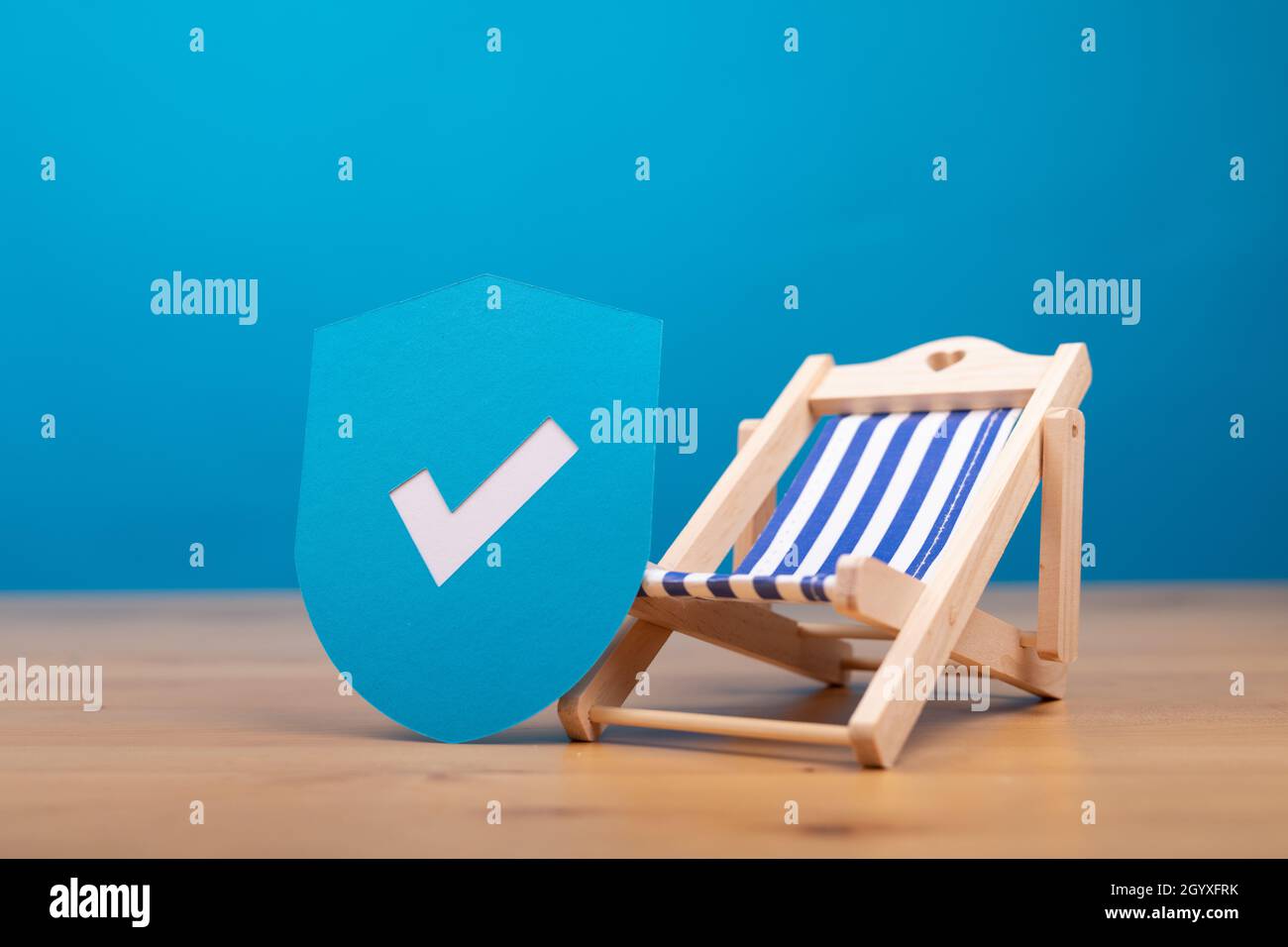 A 3D rendering of a shield beside a beach chair- safety summer vacation ...