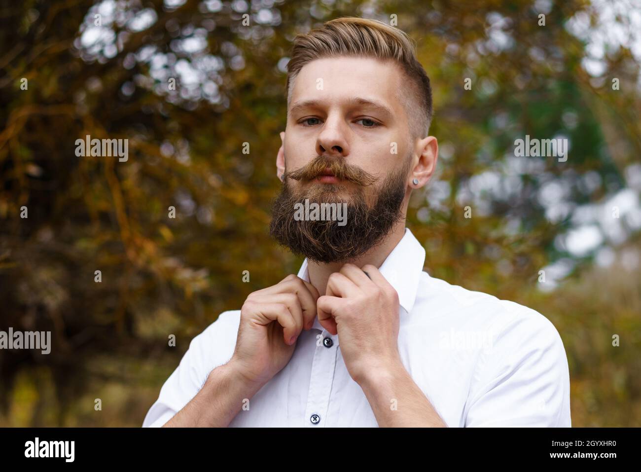 Autumn mood. Pensive young man in white shirt, meditates and walks in ...