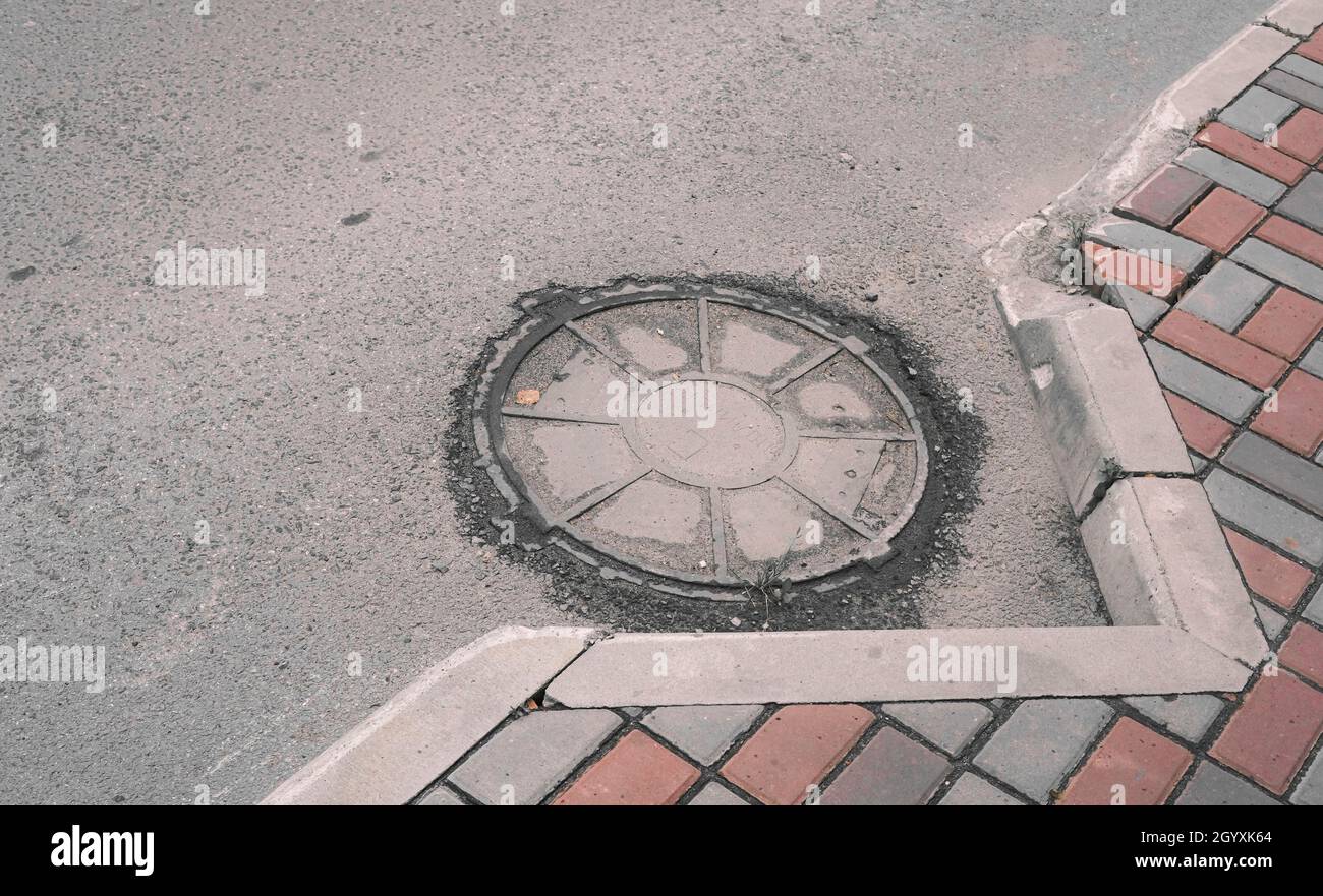 A metal well hatch on the road by the sidewalk realistic Stock Photo ...