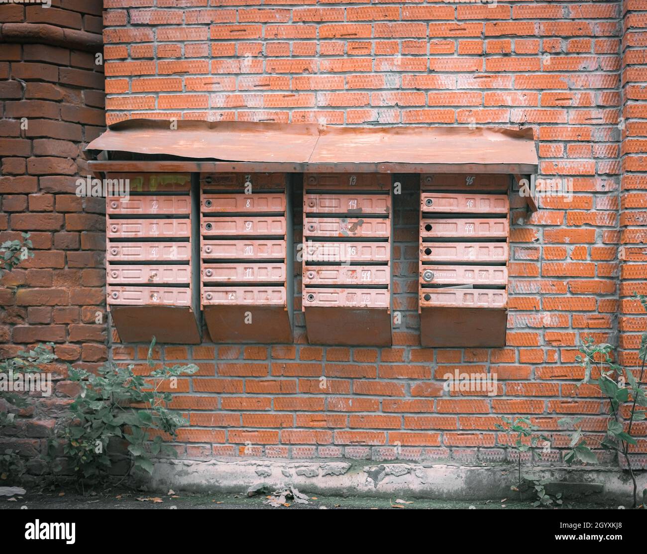 old fashioned mileboxes on the wall Stock Photo - Alamy